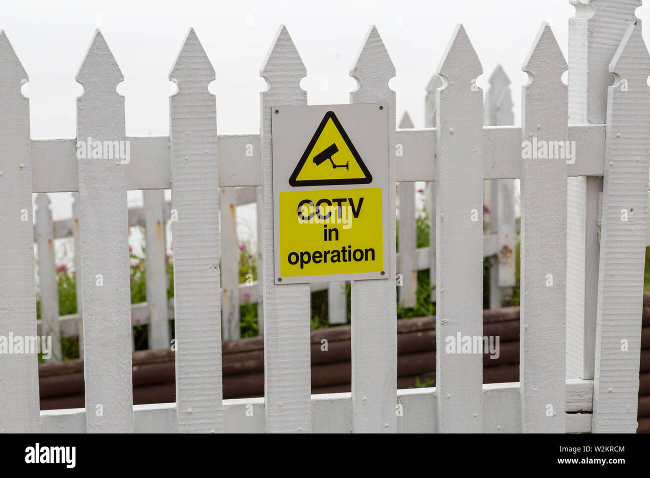 Yellow triangular CCTV warning sign Stock Photo - Alamy