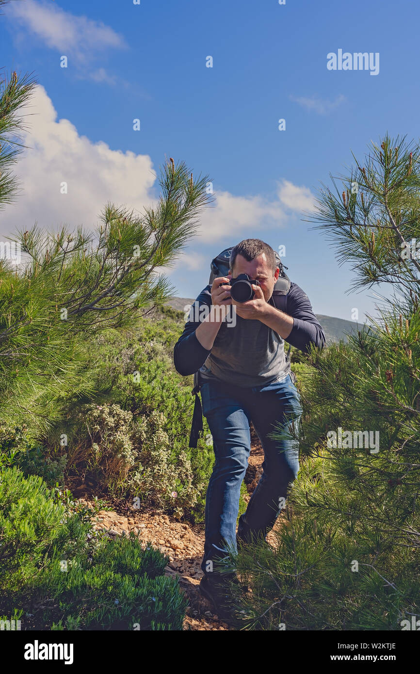 Portrait of a professional wildlife photographer hunting for animal ...