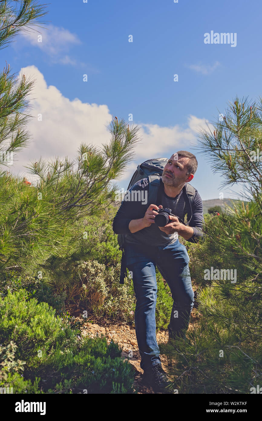 Portrait of a professional wildlife photographer hunting for animal ...