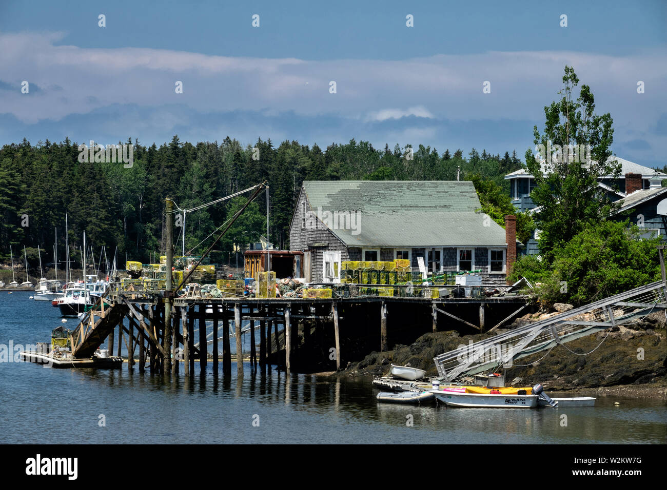 A lobster wharf piled with traps and fishing gear in the tiny village ...