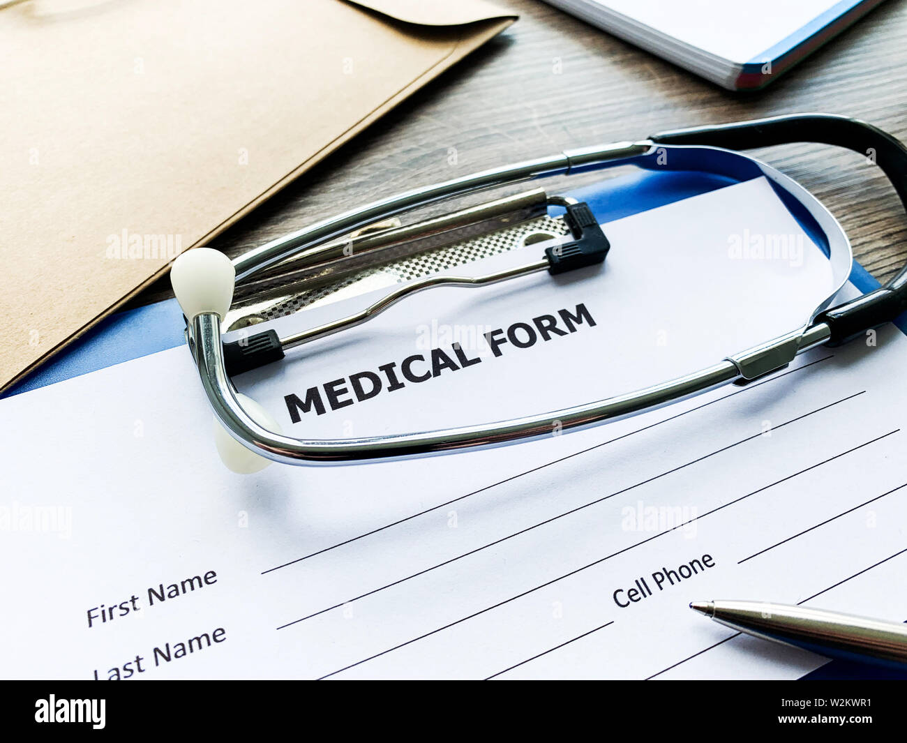 Medical form with patient data on doctor's desk Stock Photo - Alamy