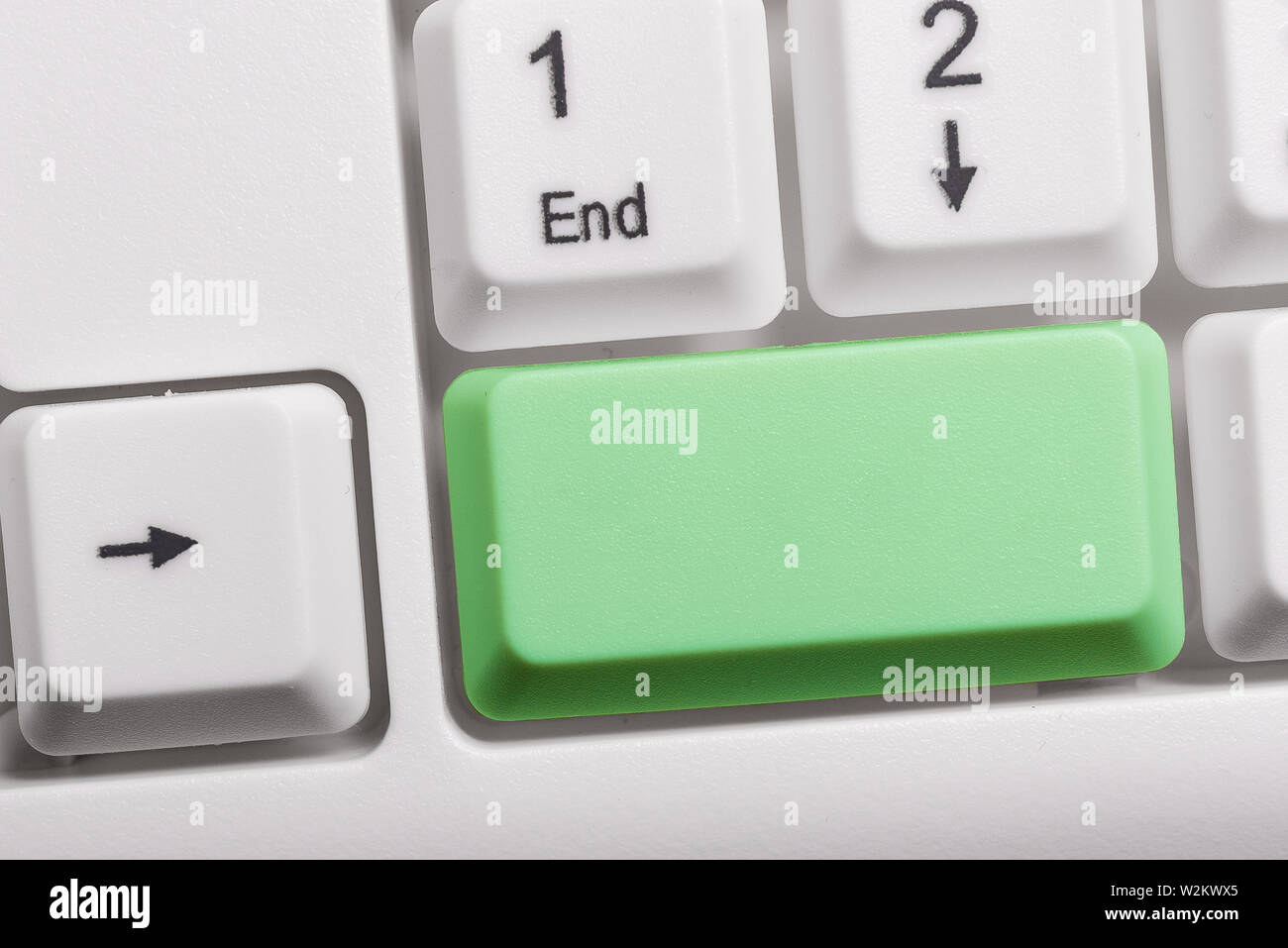 White pc keyboard with empty note paper above white background key copy ...
