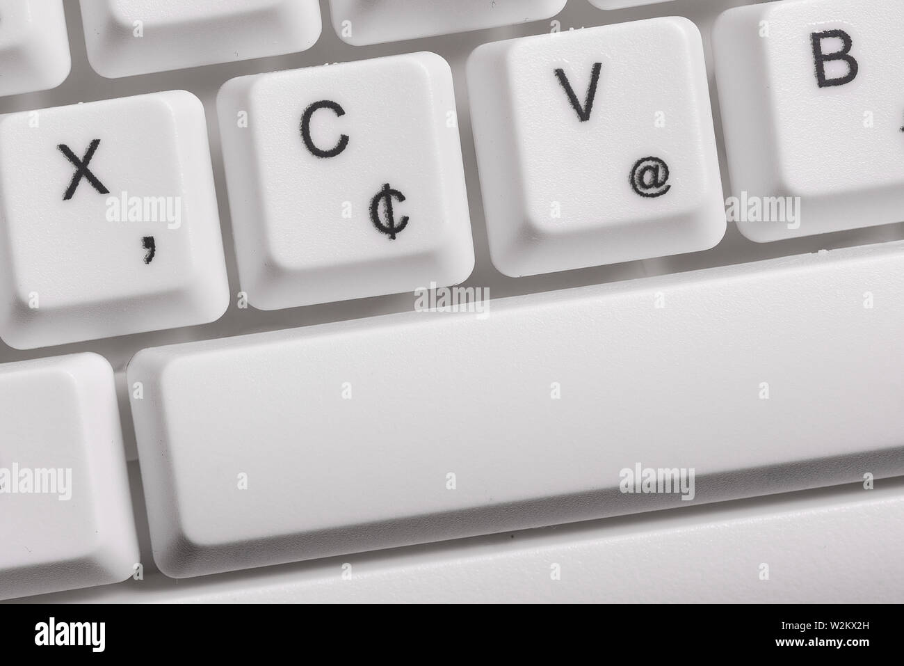 White pc keyboard with empty note paper above white background key copy ...