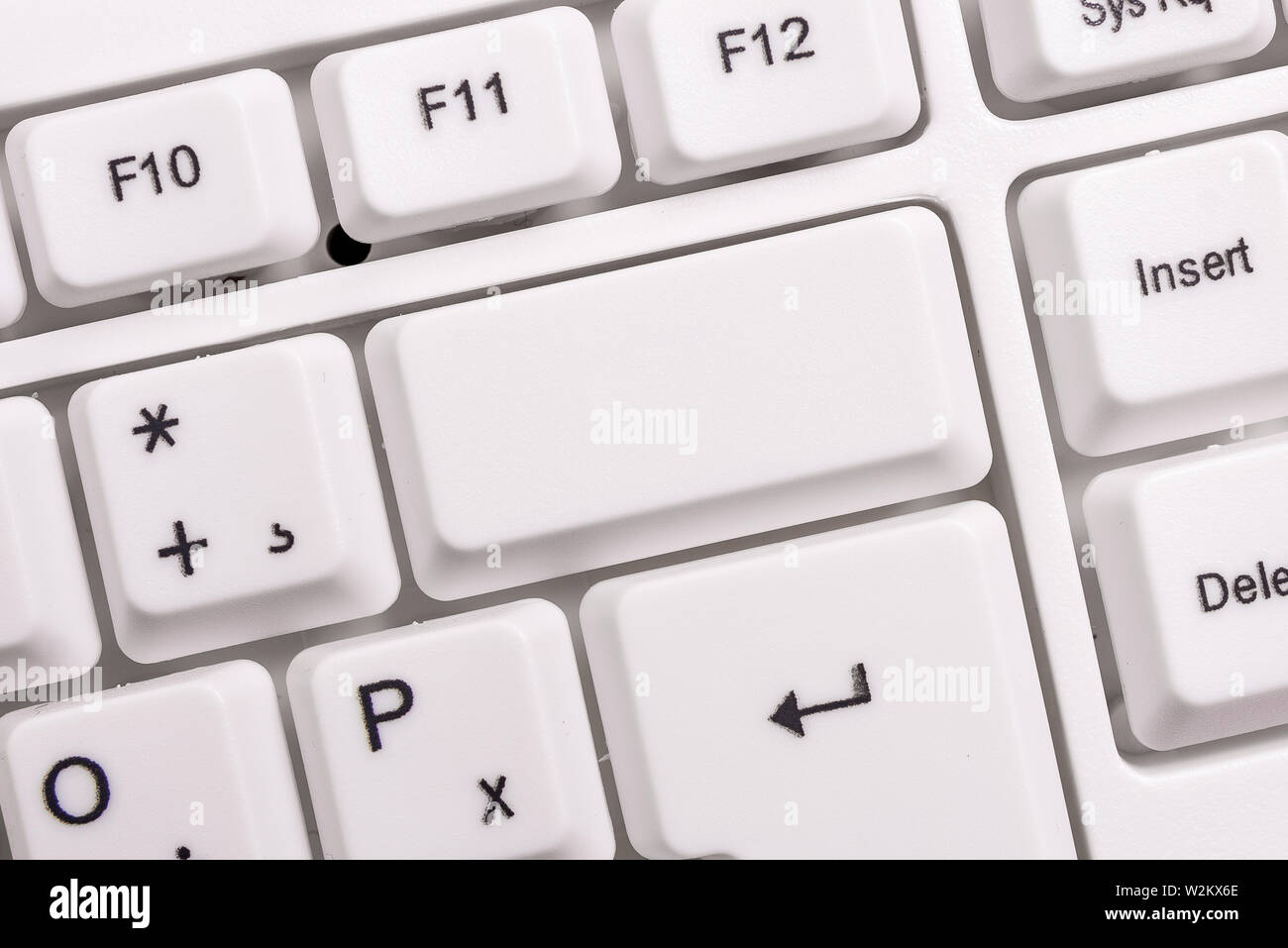 White pc keyboard with empty note paper above white background key copy ...
