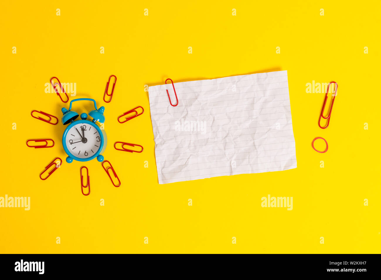 Metal vintage alarm clips crushed sheet rubber band colored background ...