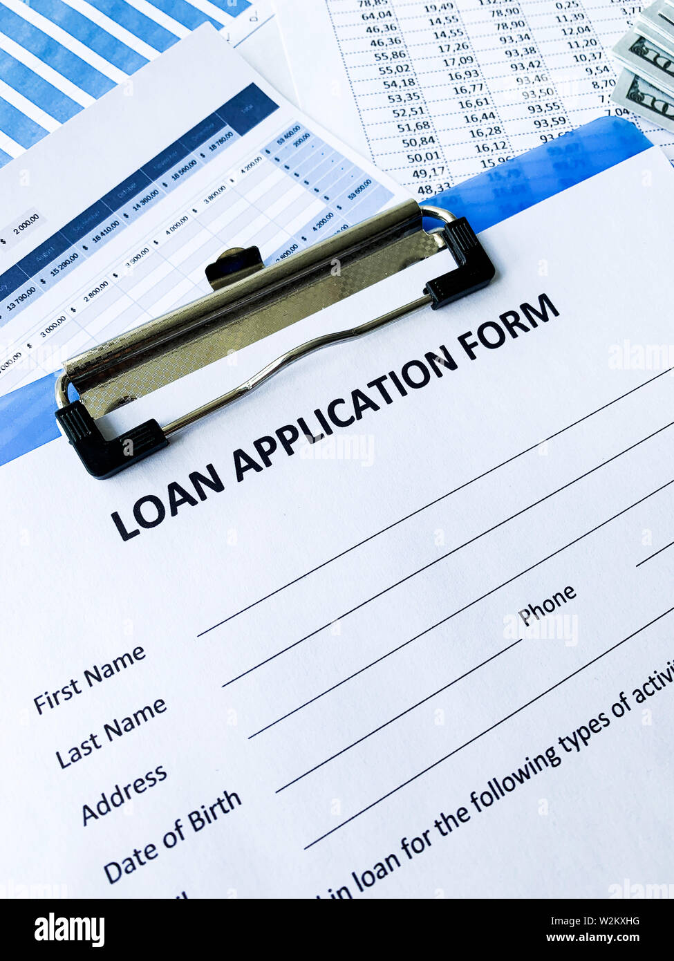 Loan application form document with graph on table Stock Photo - Alamy