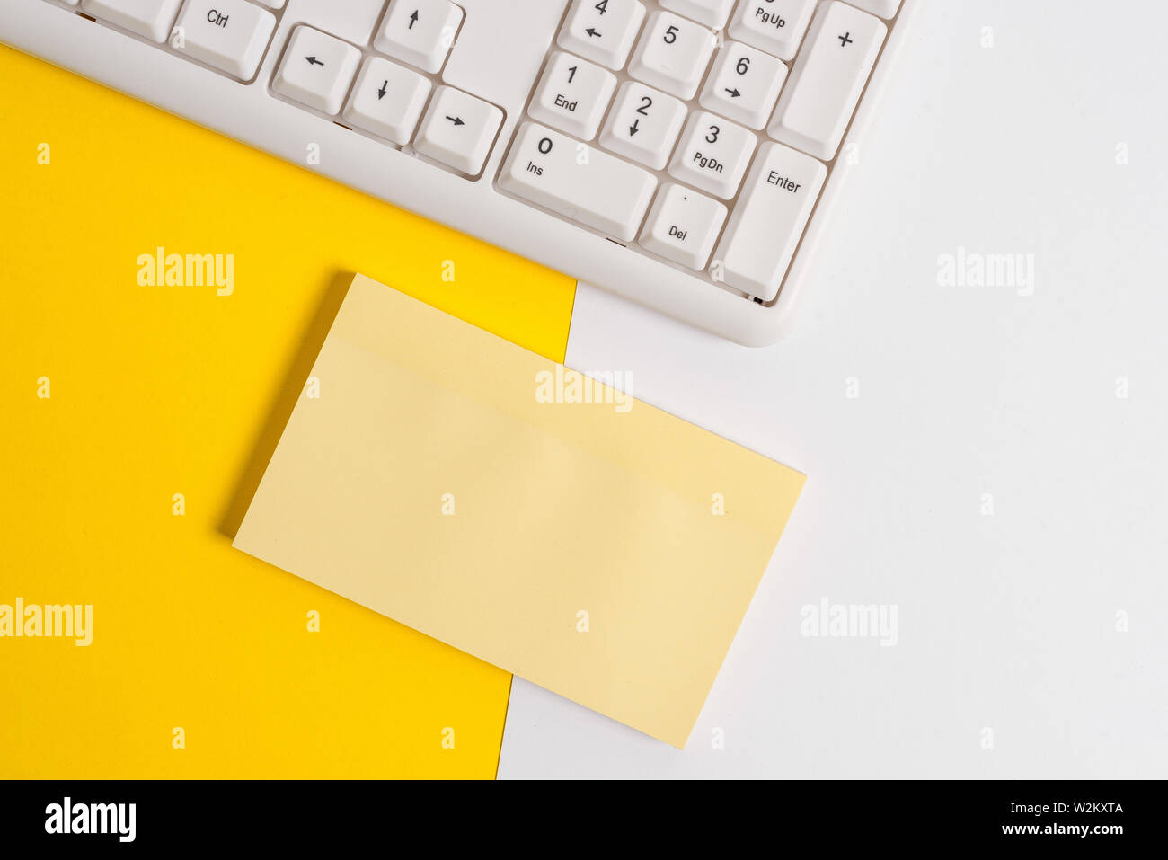 Empty blank paper with copy space and pc keyboard above orange ...