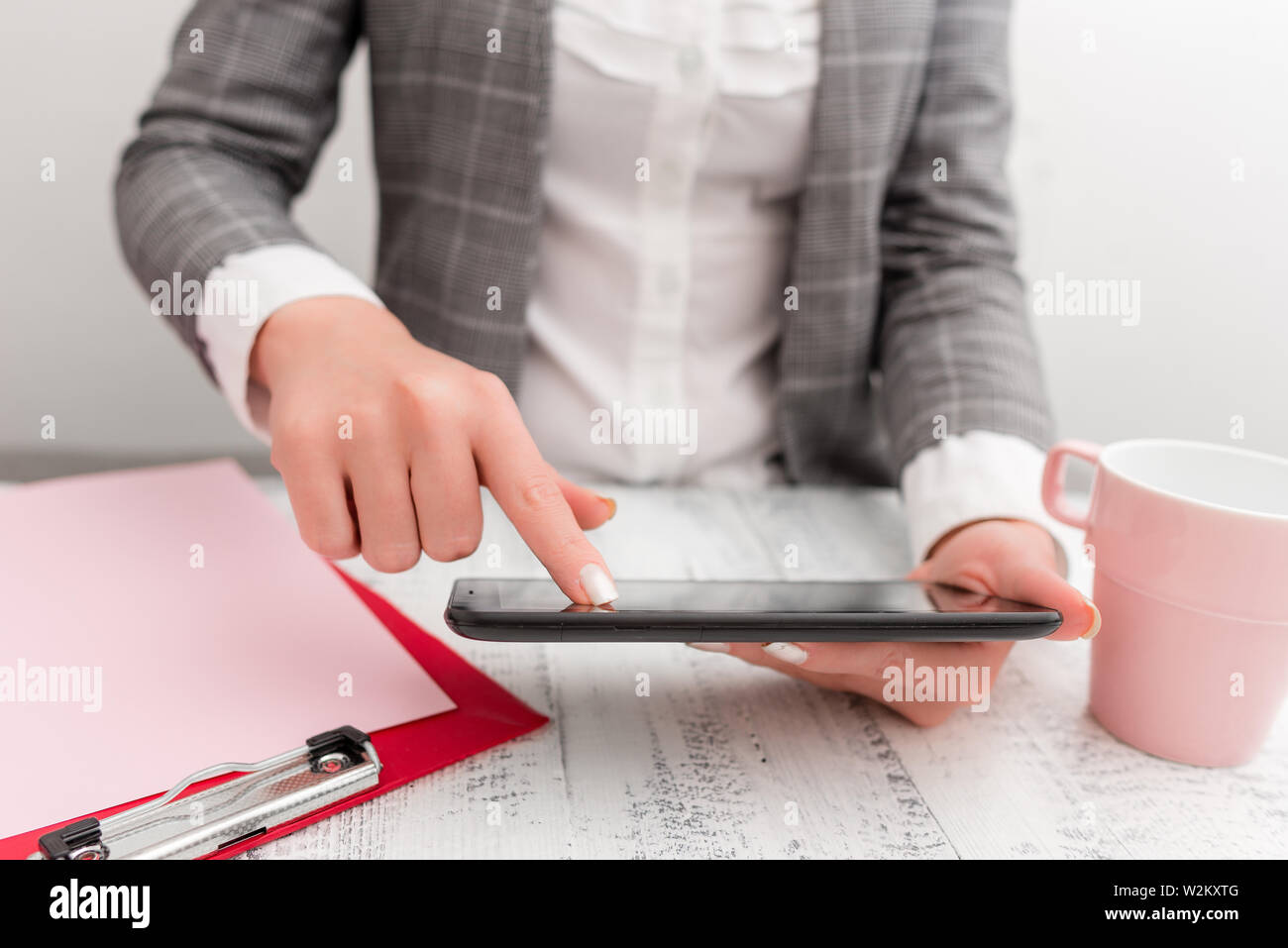 Business concept with mobile phone in the hand. Pointing with finger on ...