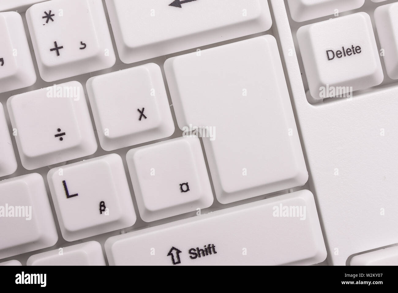 White pc keyboard with empty note paper above white background key copy ...