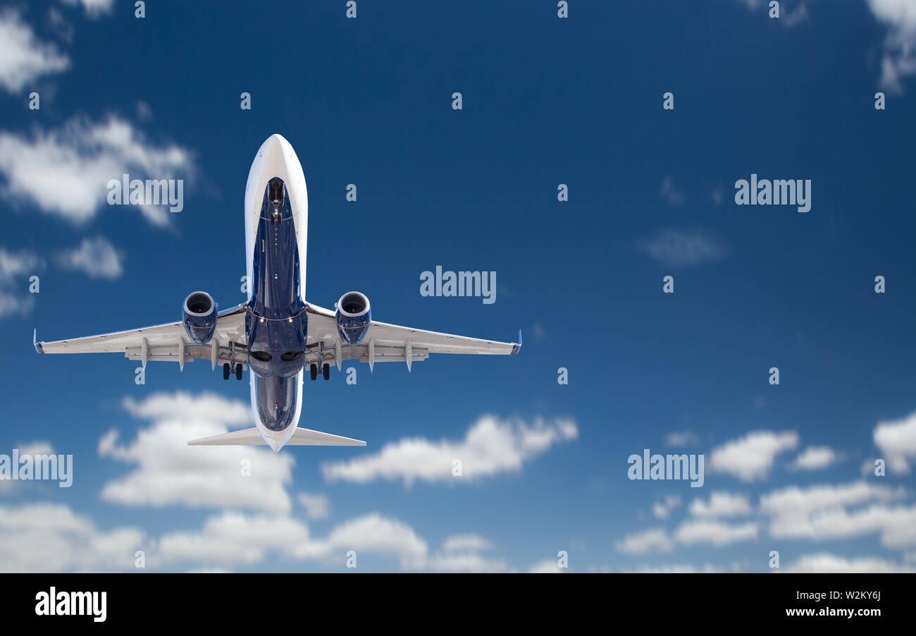 Bottom View of Passenger Airplane Flying In The Blue Sky Stock Photo ...