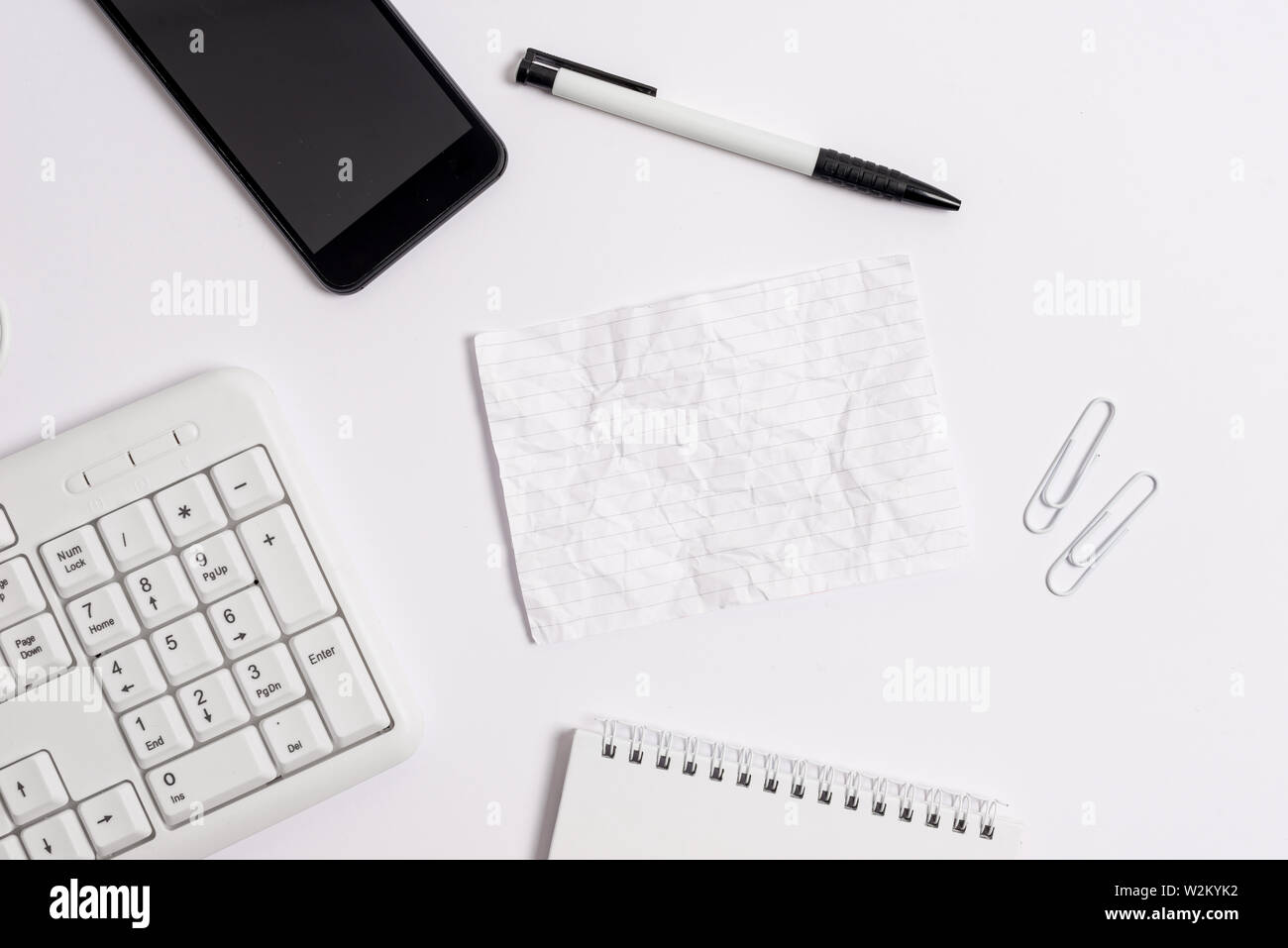 Flat lay above computer mobile phone pencil and copy space note paper ...