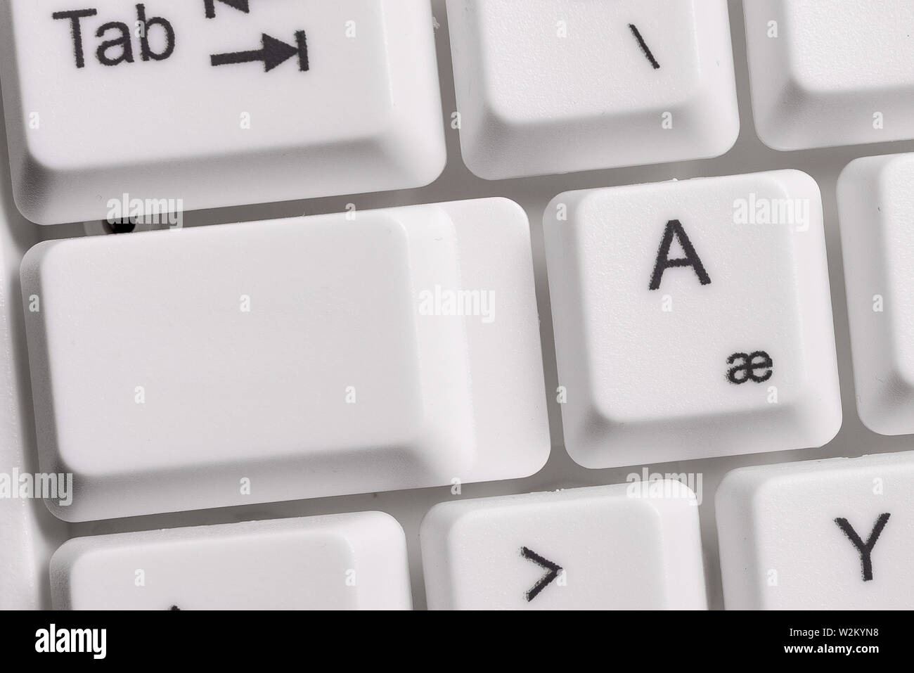 White pc keyboard with empty note paper above white background key copy ...