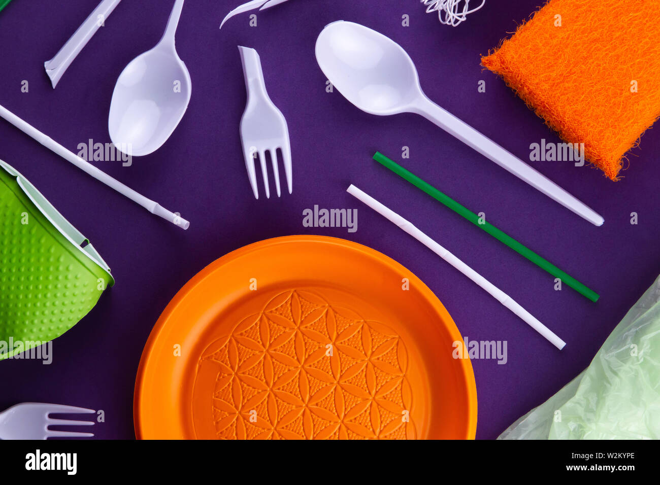 Plastic orange green waste collection on purple background. Concept of ...