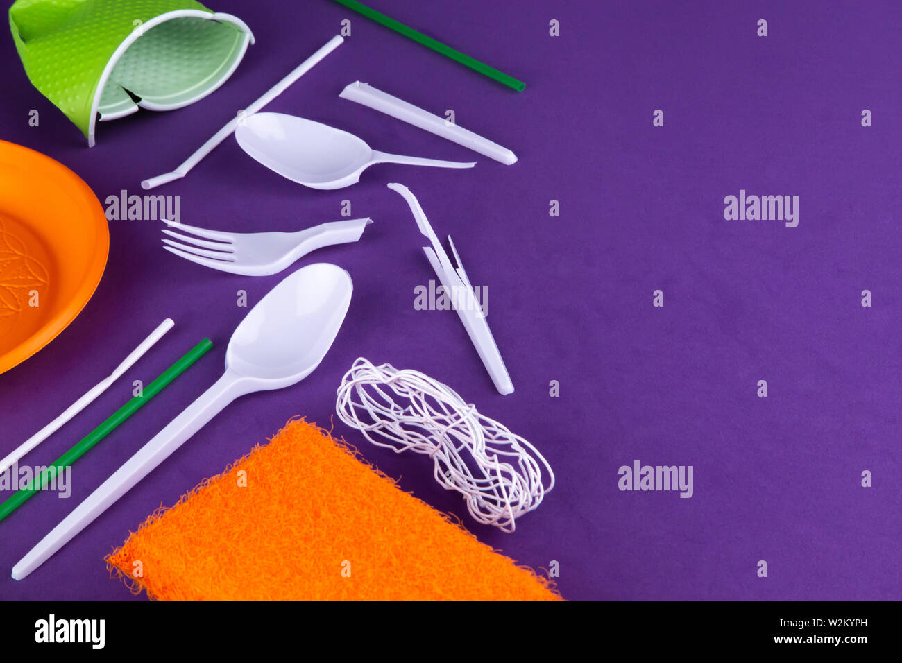 Single-use plastic objects, ecological pollution. Plastic waste. Orange ...