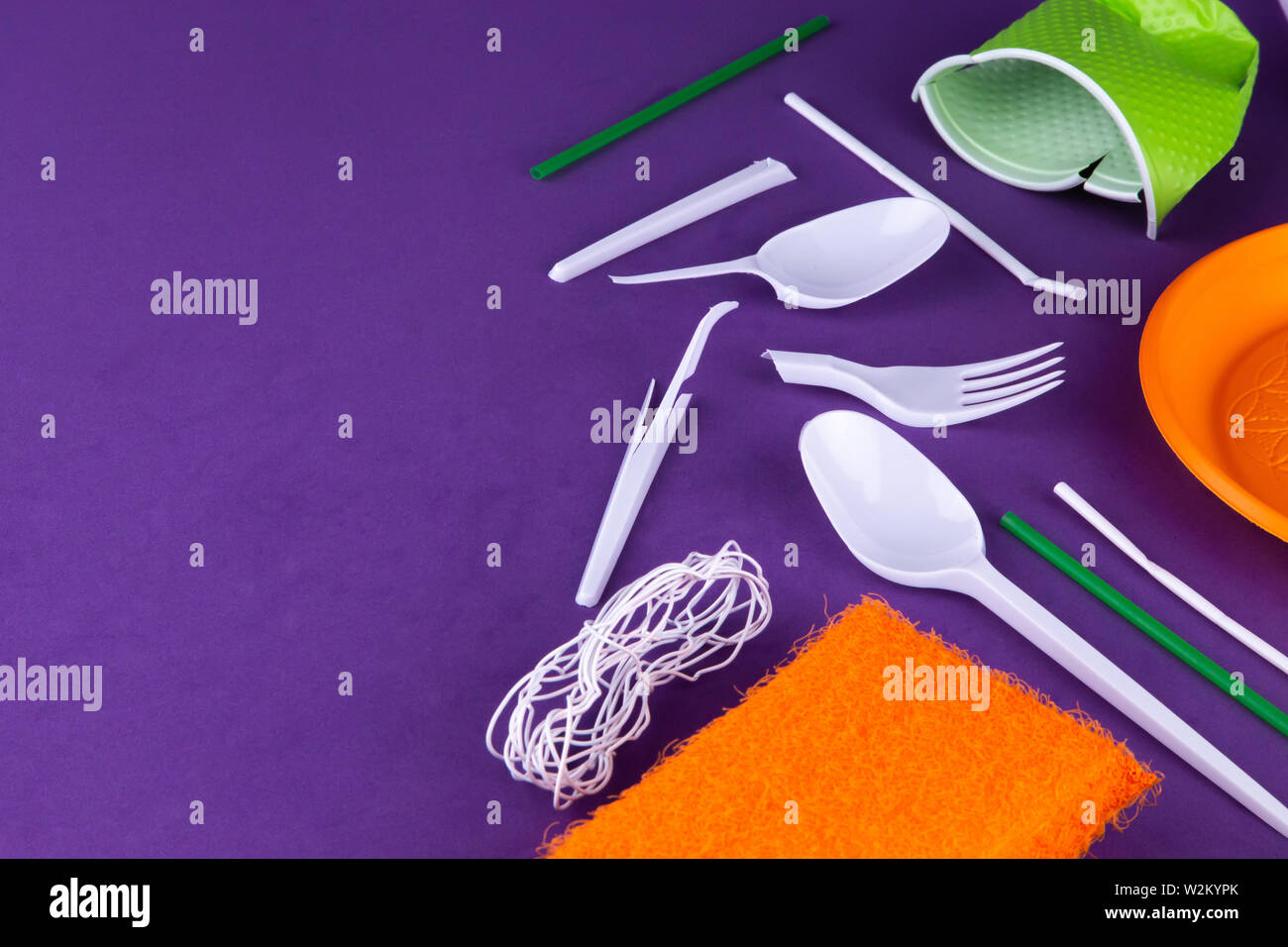 Single-use plastic objects, ecological pollution. Plastic waste. Orange ...