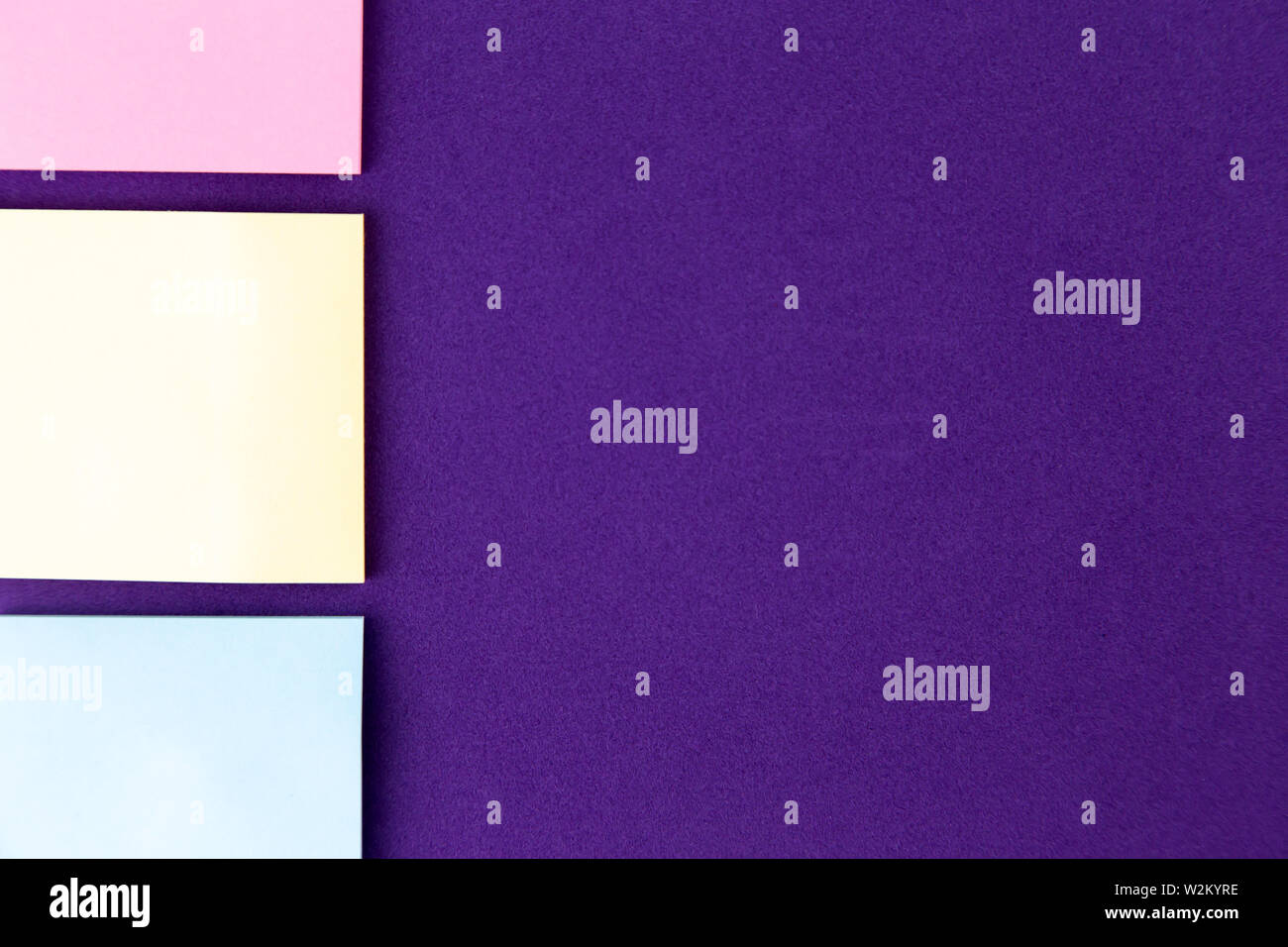 Notepad with set of colorful paper clips on purple background.business ...