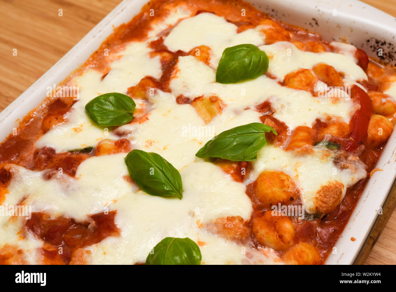 Italian pasta bake meal with melted mozzarella cheese topping on tasty ...