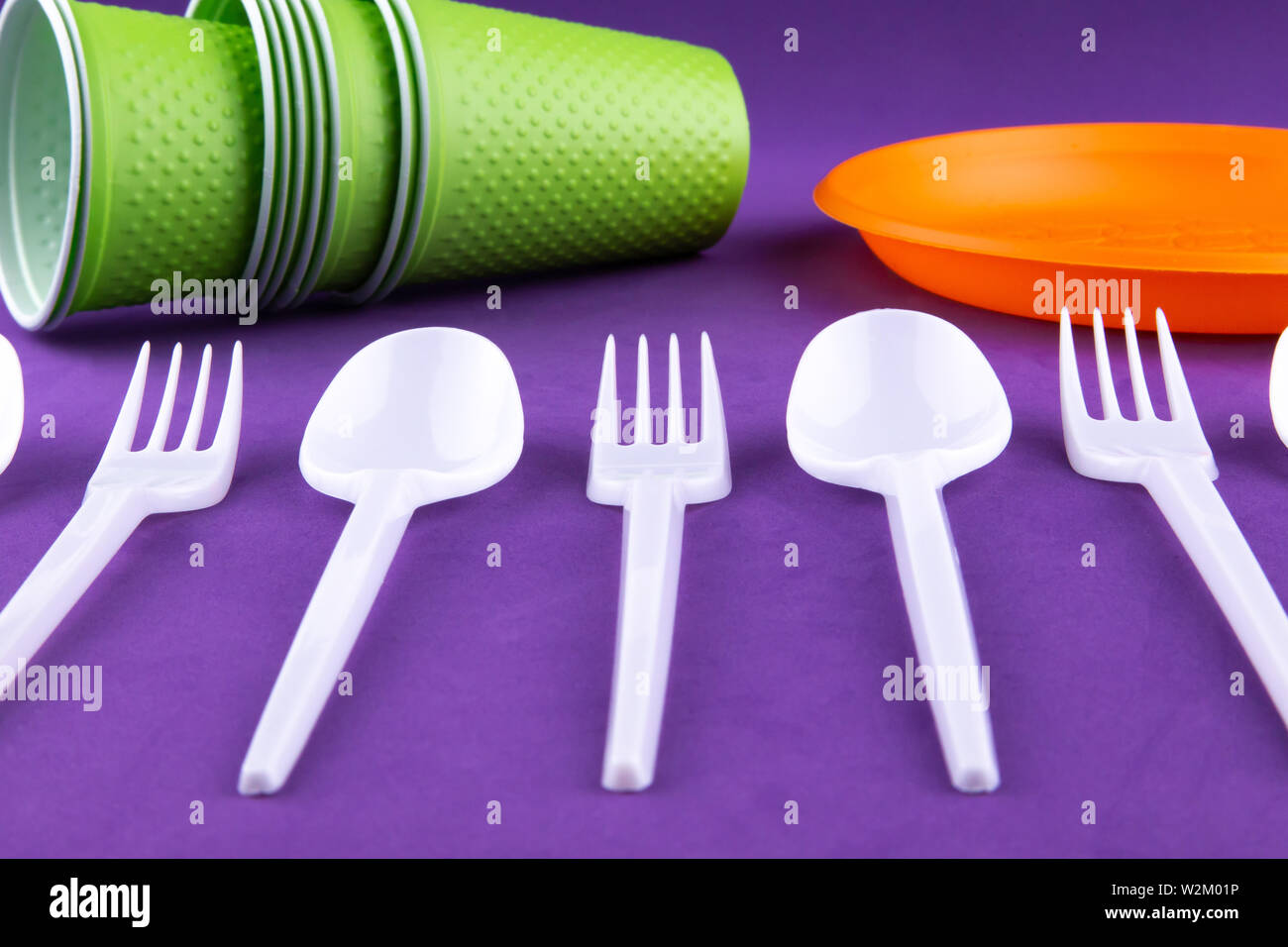 Plastic orange green waste collection on purple background. Concept of ...