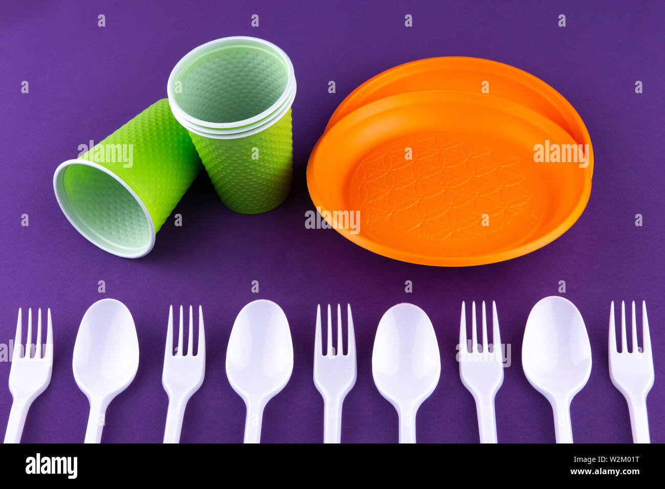 Plastic orange green waste collection on purple background. Concept of ...