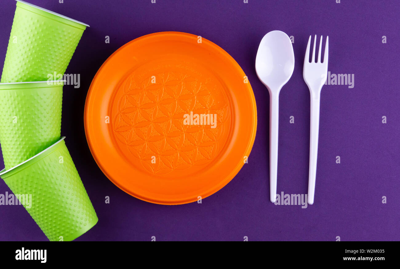 Plastic orange green waste collection on purple background. Concept of ...