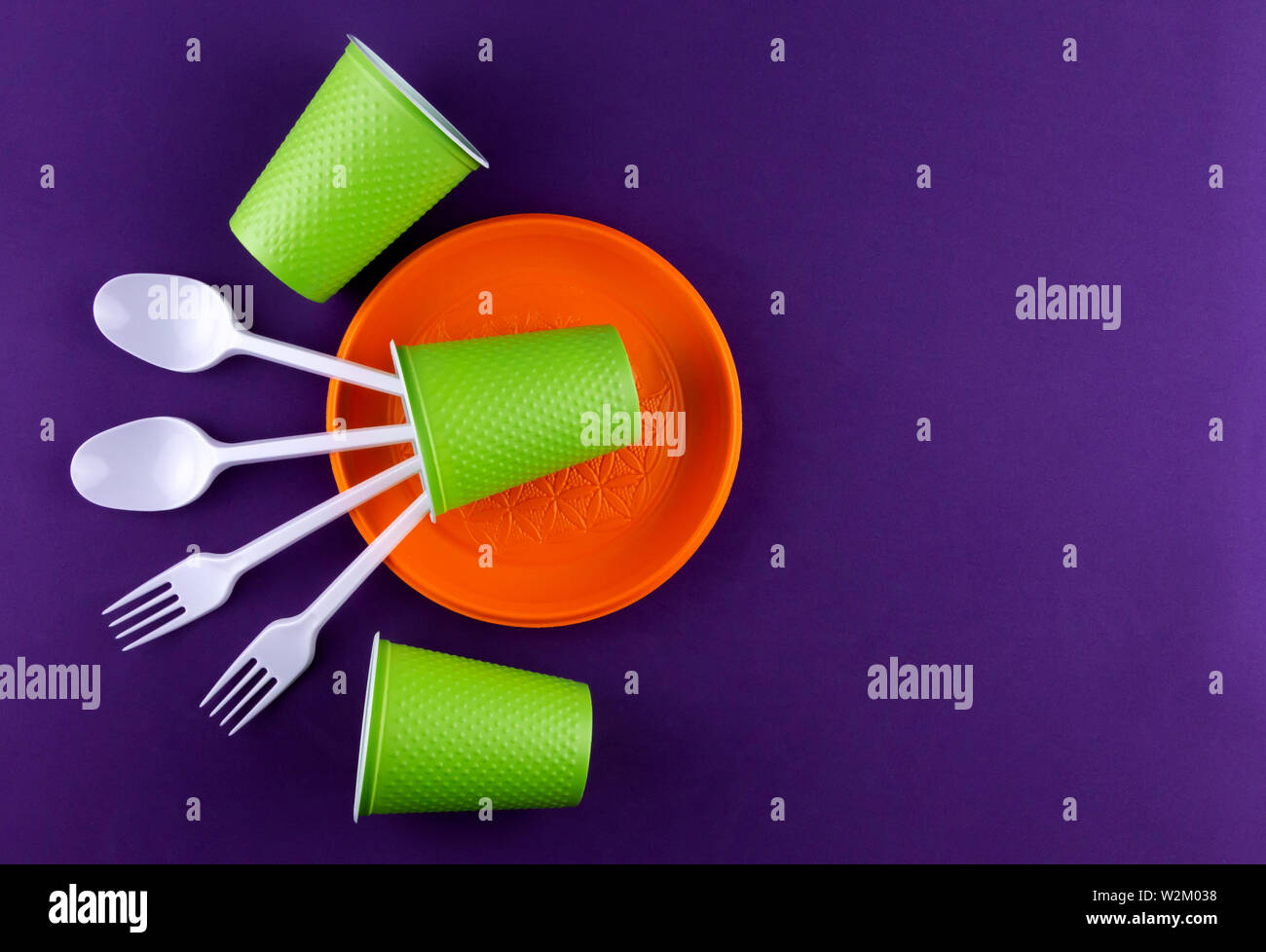 Single-use plastic objects, ecological pollution. Plastic waste. Orange ...