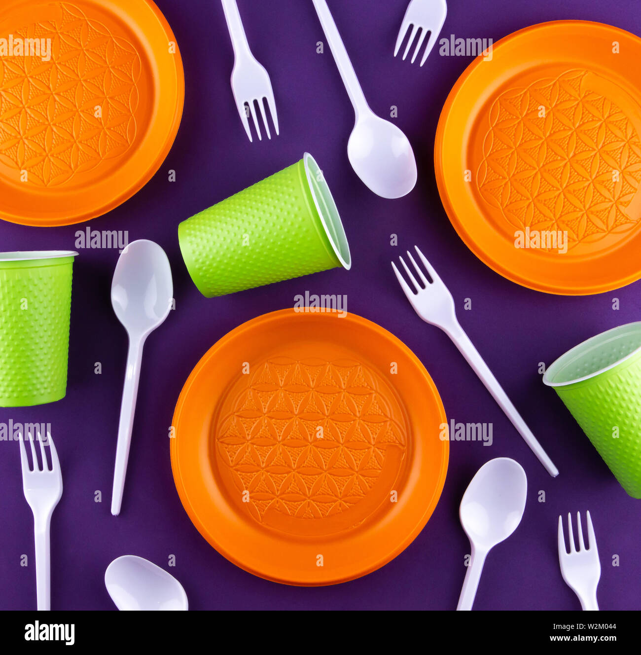 Plastic orange green waste collection on purple background. Concept of ...