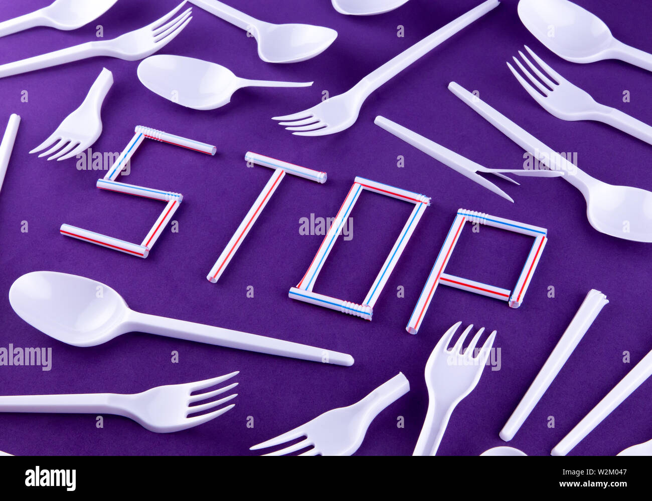 The word stop made of plastic tubes on a purple background with plastic ...