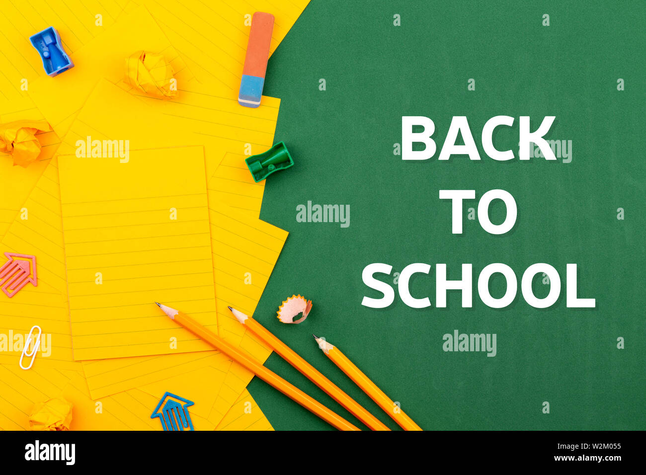 Back to School stationery and orange sheet of paper lie on the green ...