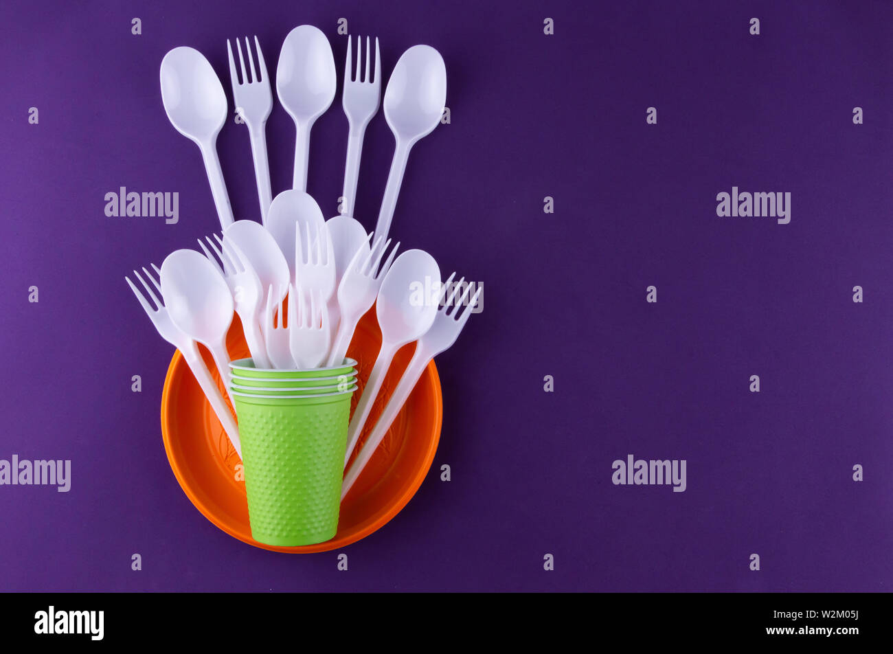 Single-use plastic objects, ecological pollution. Plastic waste. Orange ...