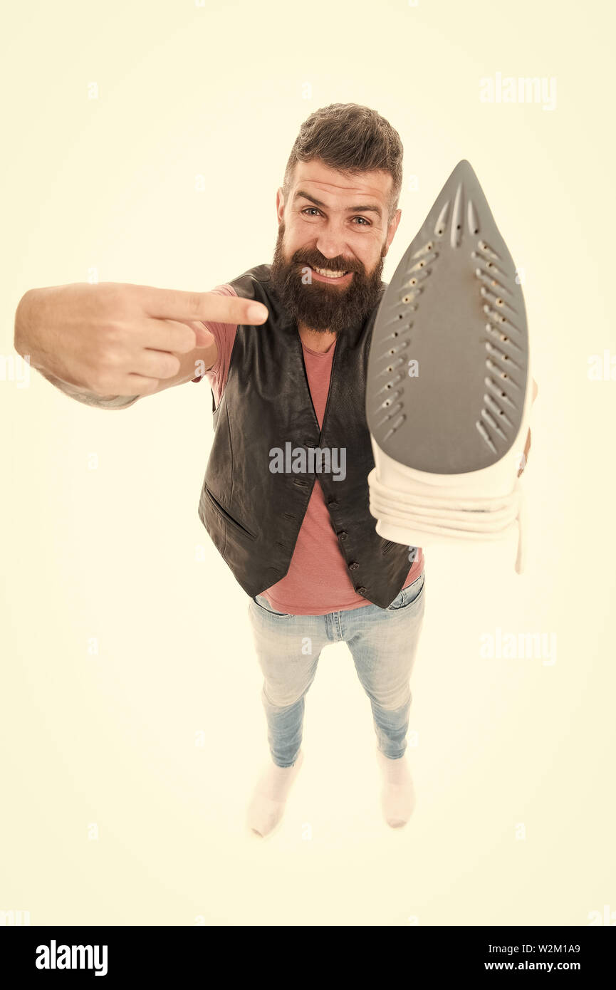 Household ironing. Bearded man pointing at clothes iron. Hipster ...
