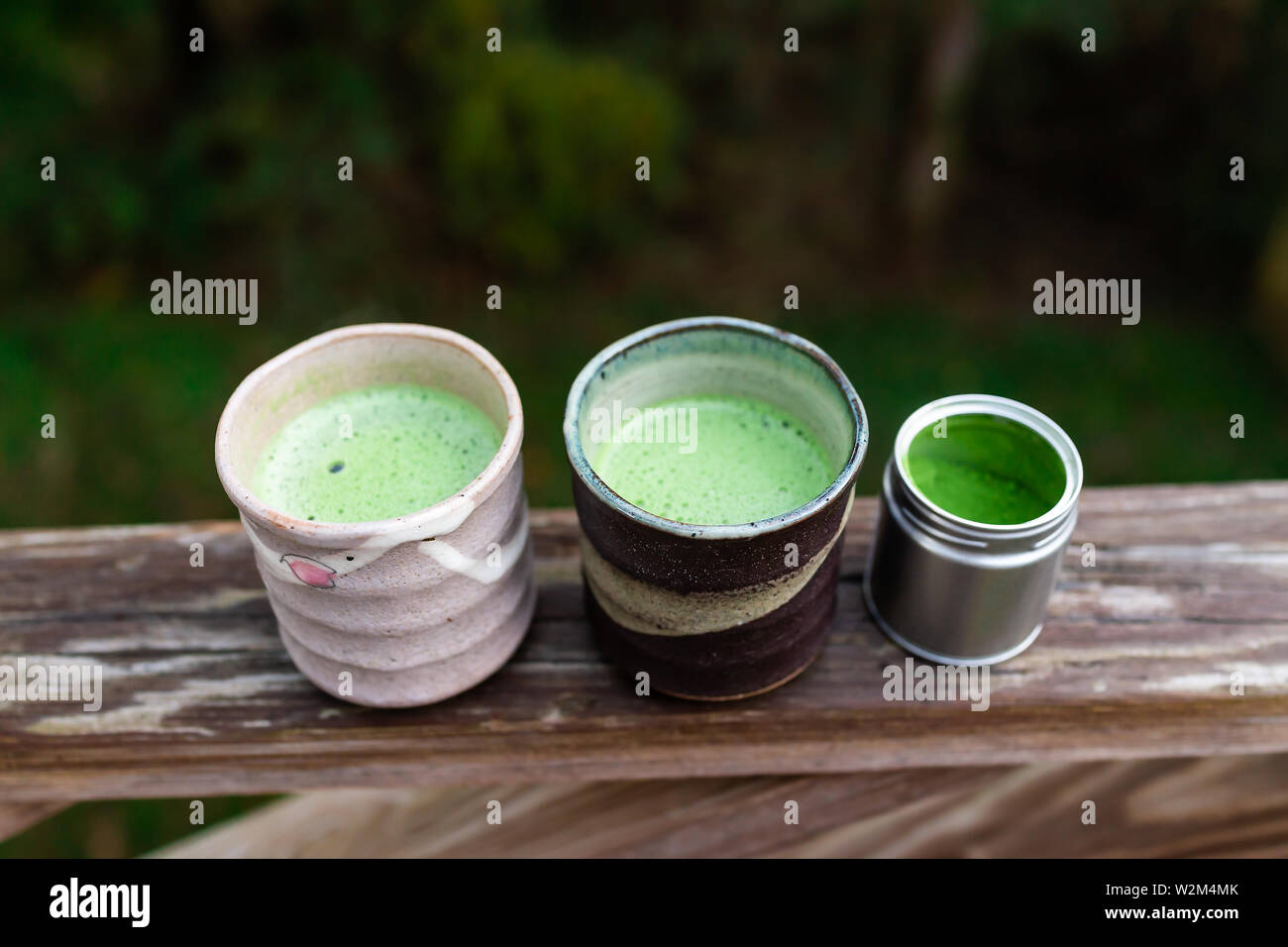 Wooden railing on backyard deck garden and two cups with Japanese ...