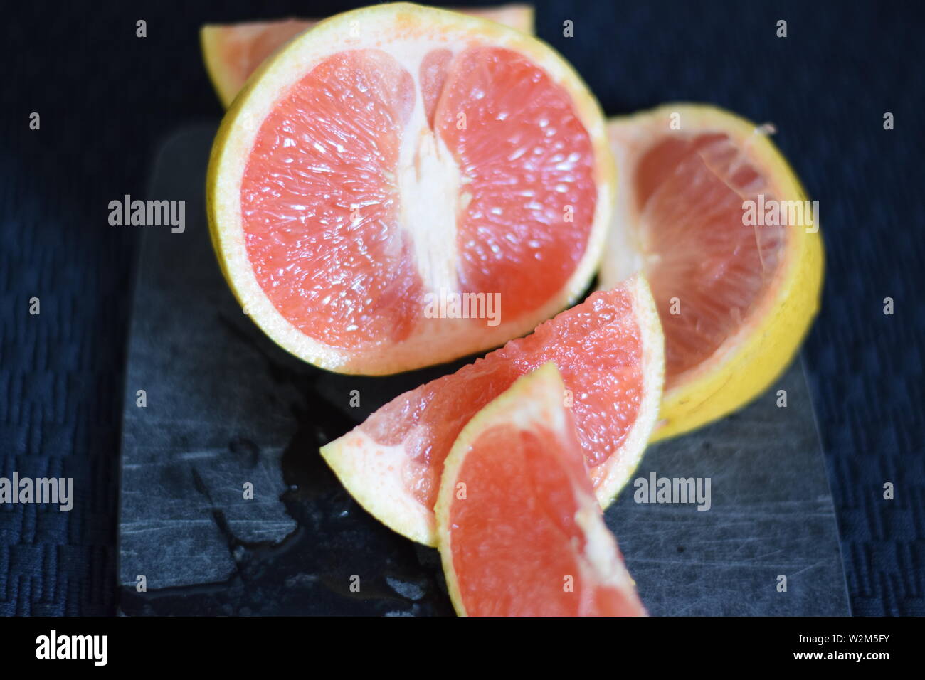 grapefruit sliced on cutting board citrus fruit Stock Photo - Alamy