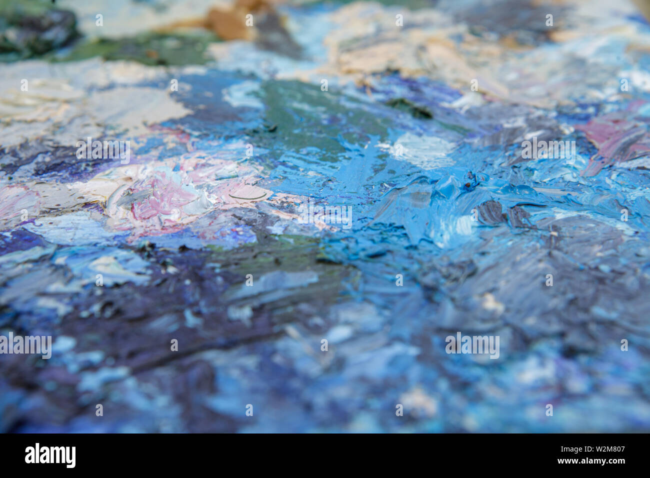 Abstract artistic background from an old palette with paints dried on ...