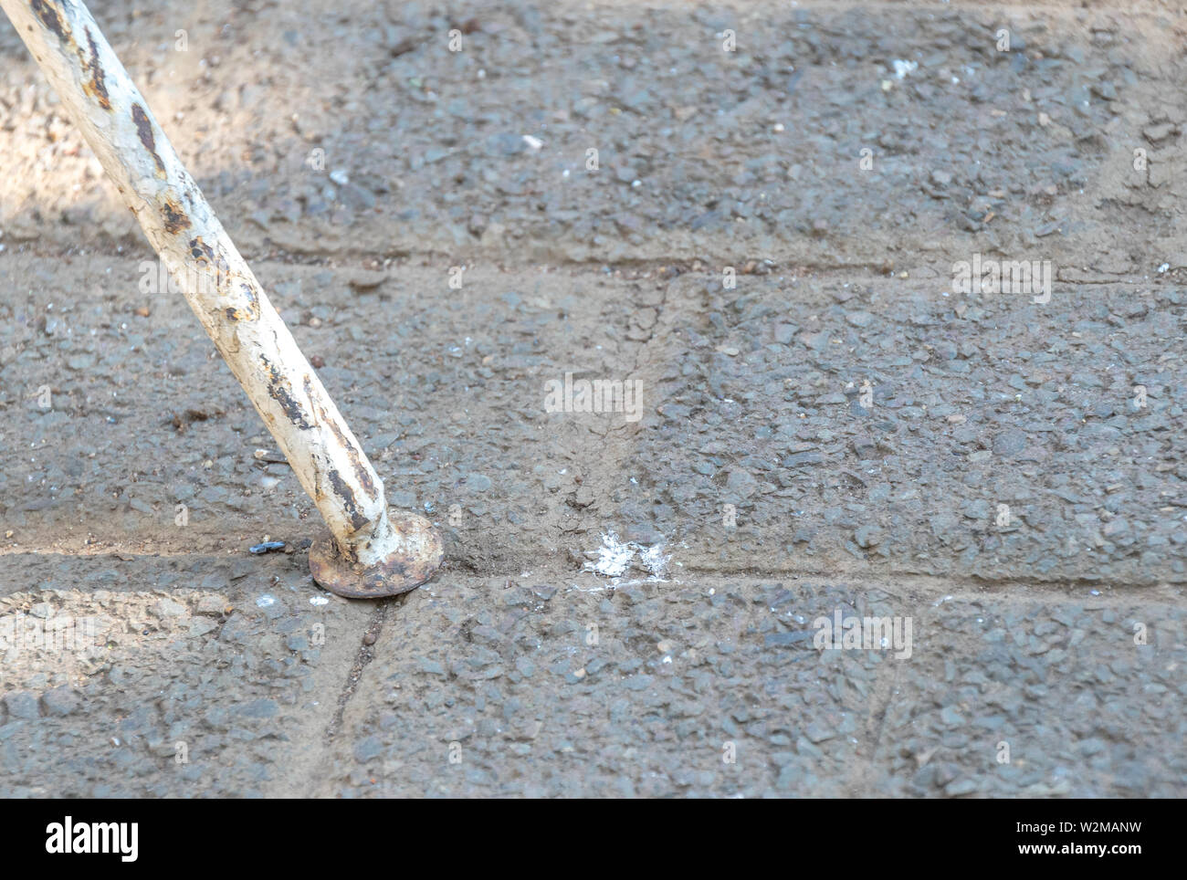 Abstract image of a rusted and weathered outdoor metal table leg ...