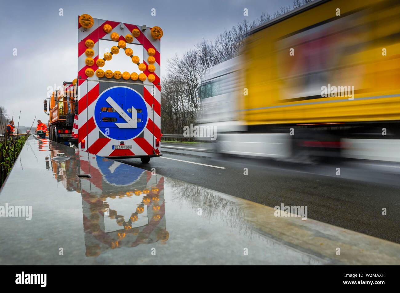 Warning for lane change on a vehicle of the motorway maintenance ...