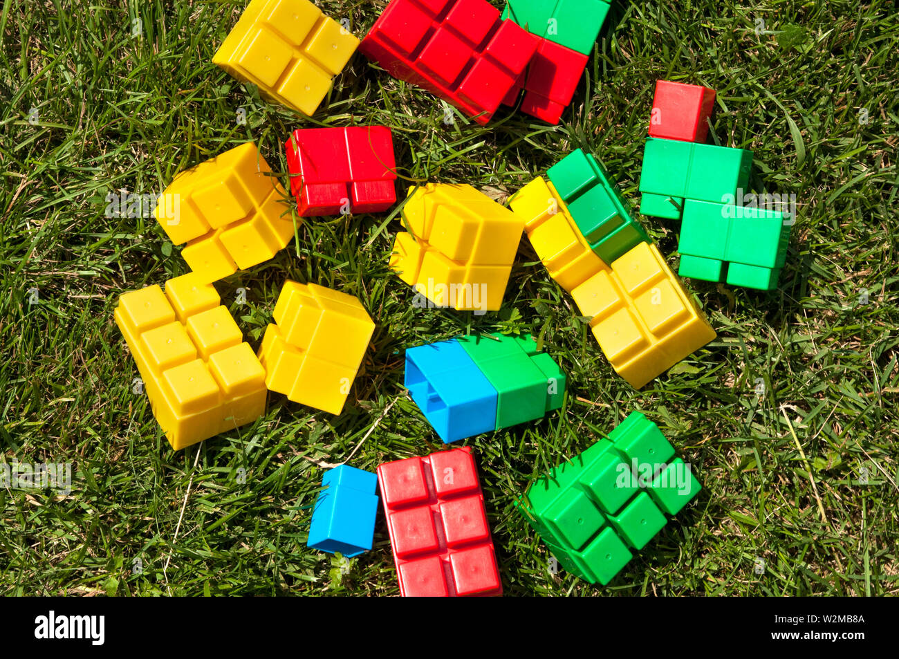green blue blue and red cubes for kids game on green grass top view ...