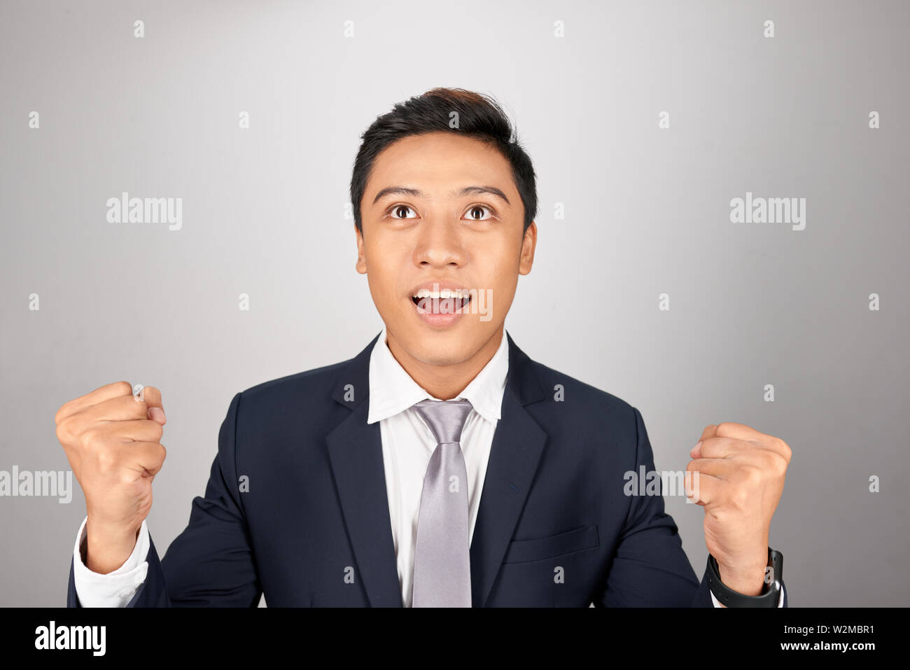 Surprised business man celebrating good hi-res stock photography and ...