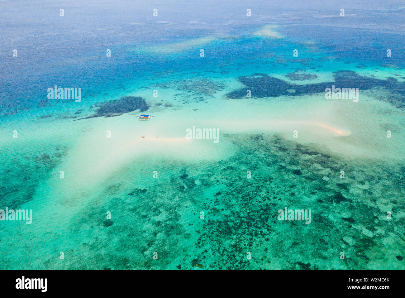 Coral reef with turquoise water and sandy shoals. Large atoll with ...