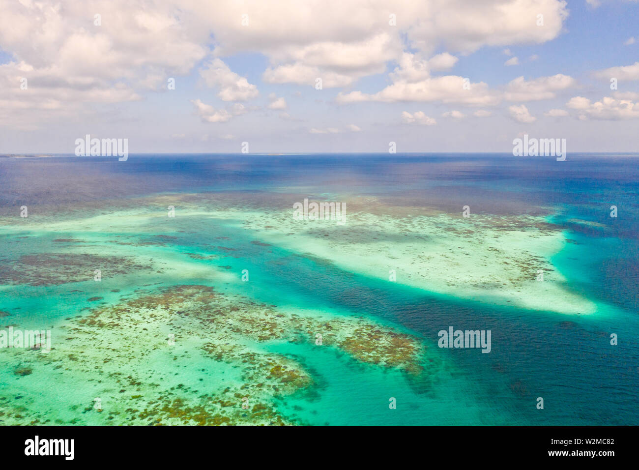 Coral reefs and atolls in the tropical sea, top view. Turquoise sea ...