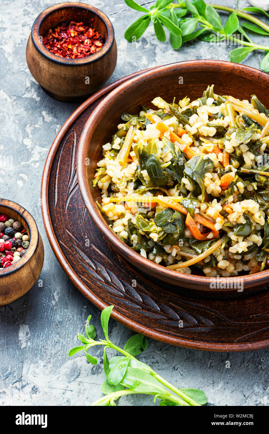 Popular food of the Middle East.Stew bulgur.Bulgur with portulak Stock ...