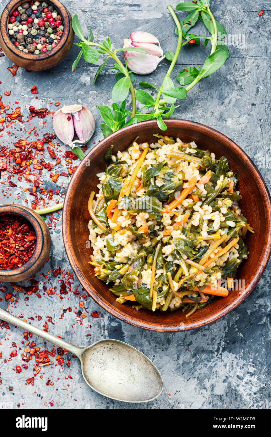 Popular food of the Middle East.Stew bulgur.Bulgur with portulak Stock ...