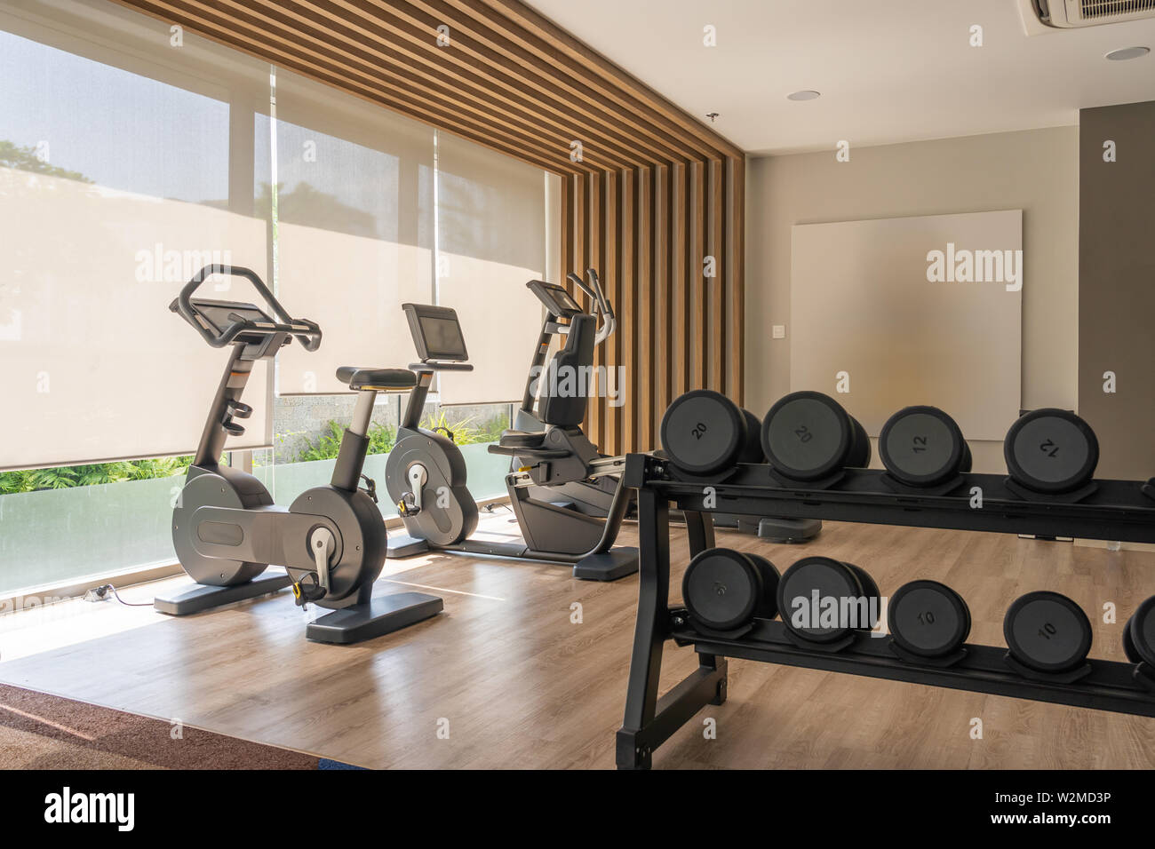 Luxury interior fitness machine and dumbbells in gym club Stock Photo ...