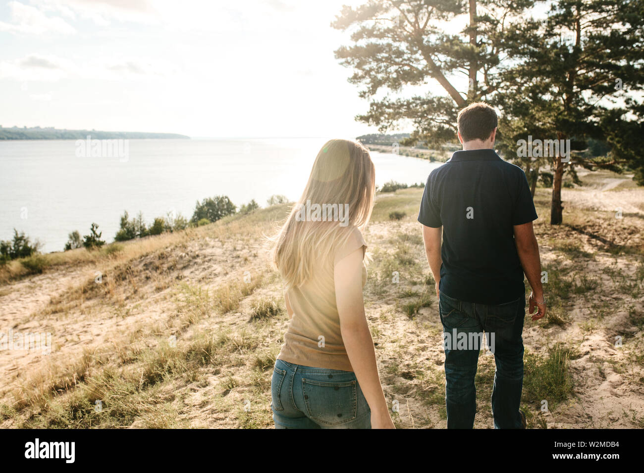 The couple walks together in a natural landscape. Traveling together or ...