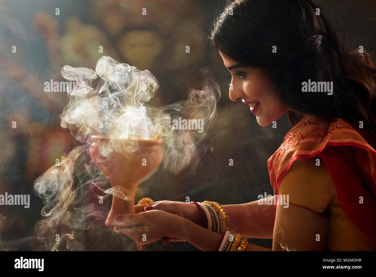 Bengali Married woman doing a Dhunuchi dance on the occasion of durga ...