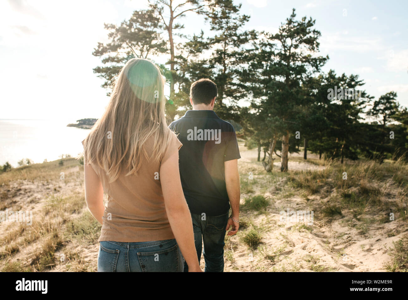 The couple walks together in a natural landscape. Traveling together or ...