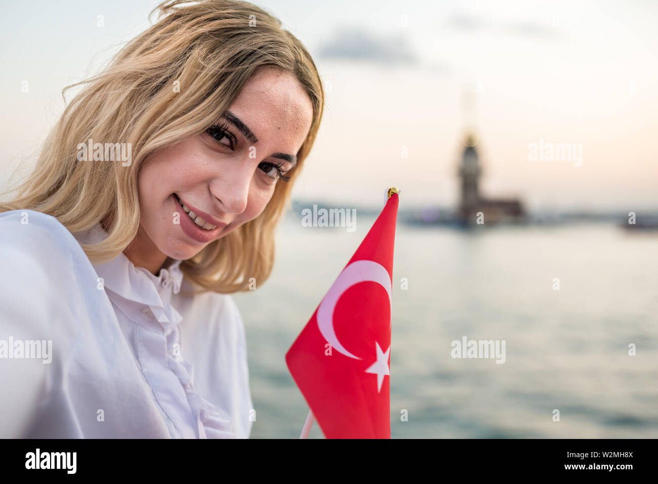 Attractive young beautiful takes selfie while waving Turkish flag and ...