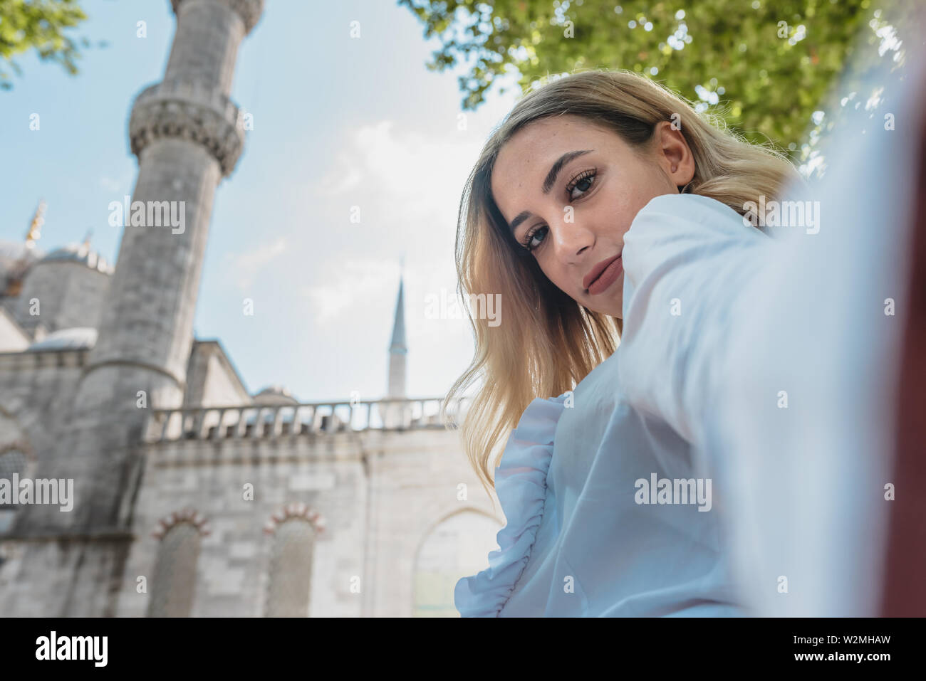 Attractive beautiful gir takes selfie wtih view of Sultan Ahmet Mosque ...