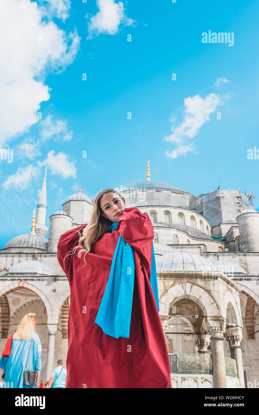Attractive beautiful girl with covered clothes poses in front of Sultan ...