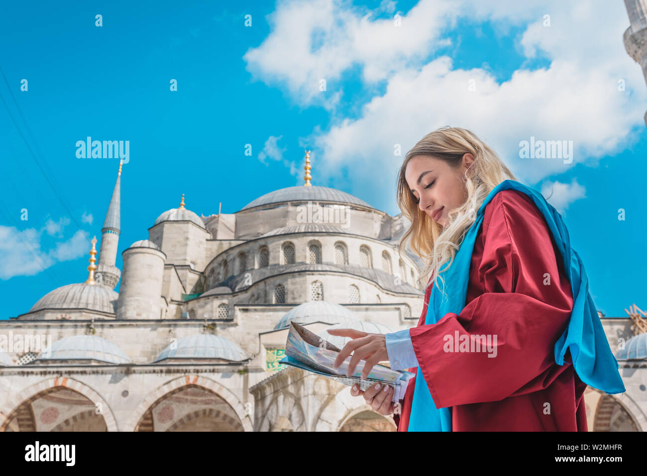 Attractive beautiful girl with covered clothes looks Turkish map with ...