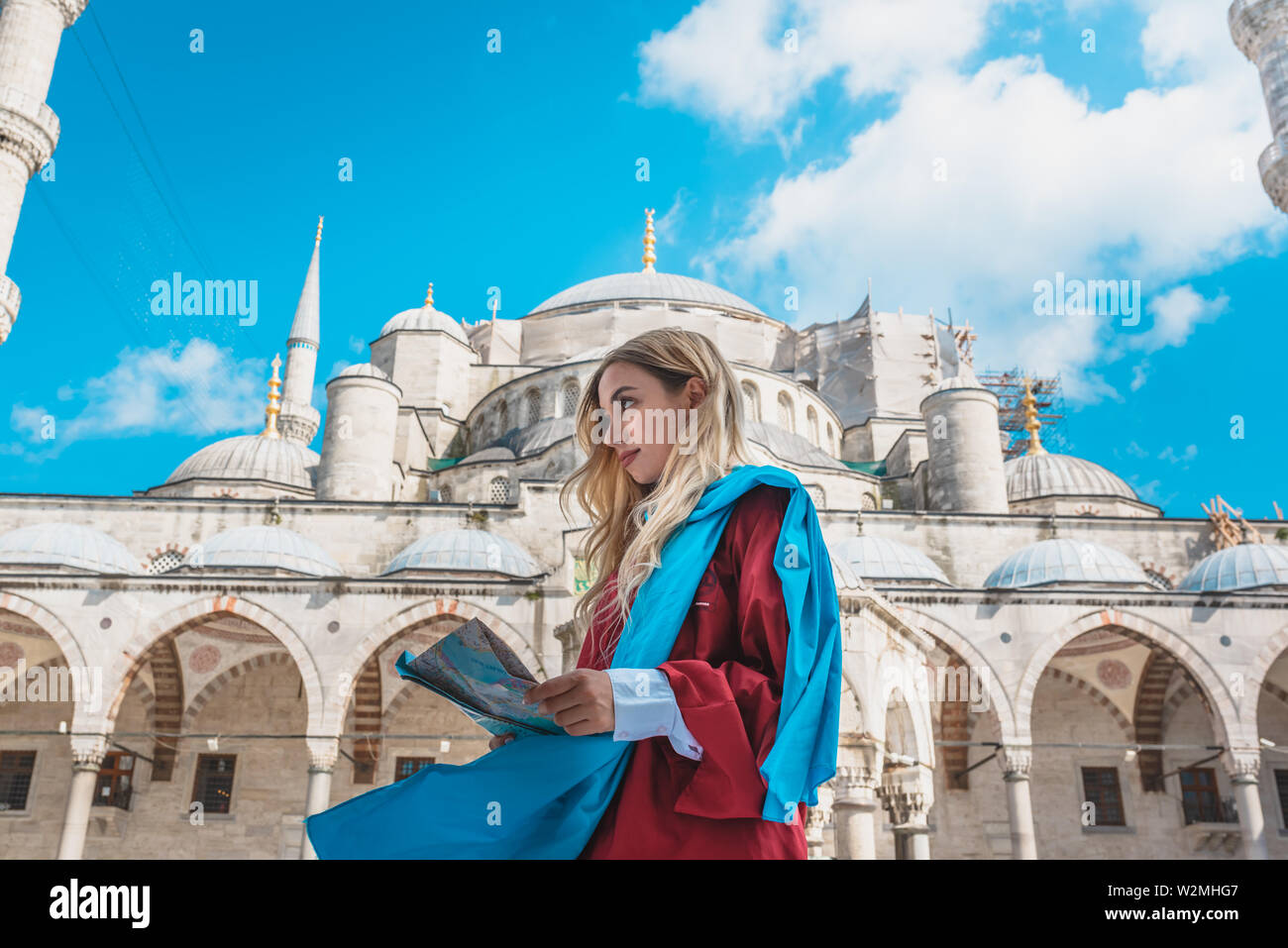 Attractive beautiful girl with covered clothes looks Turkish map with ...